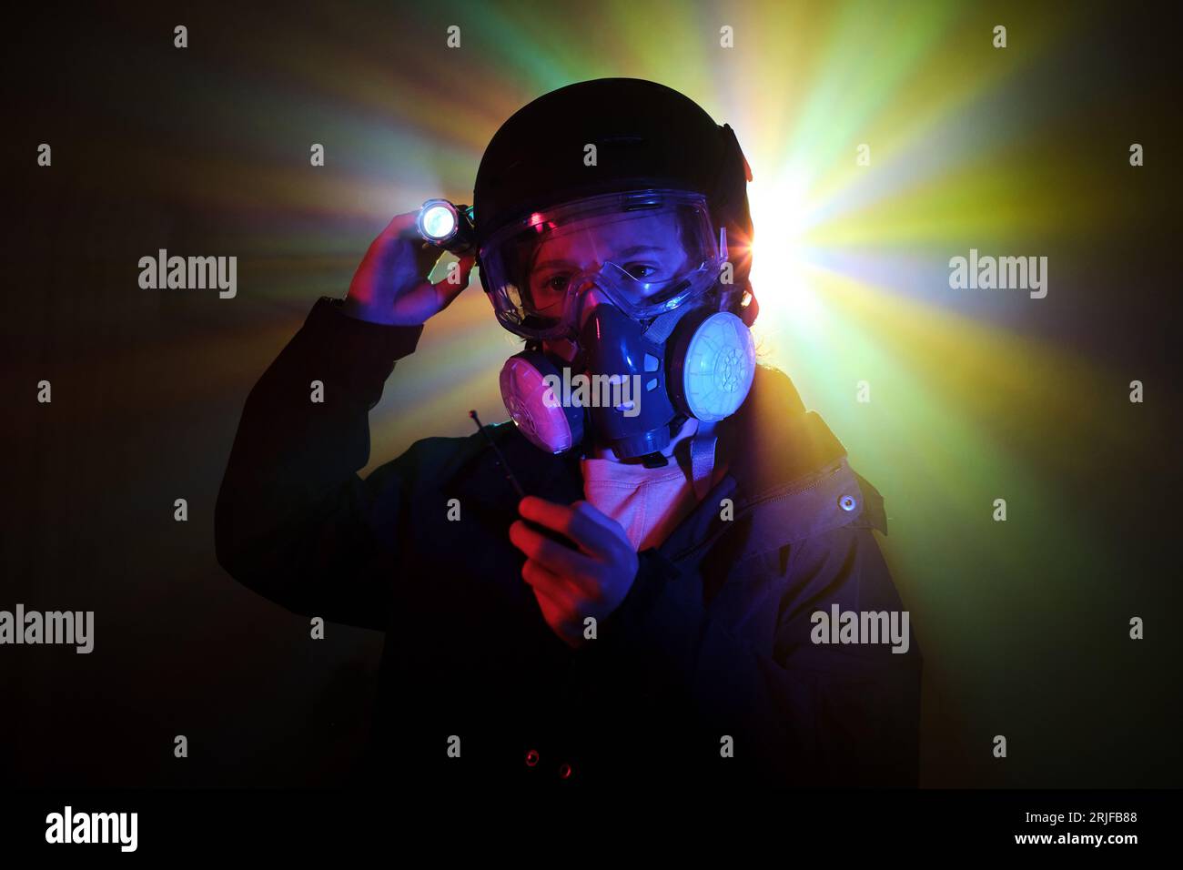 Boy in gas mask with portable walkie talkie in hand shining bright ...
