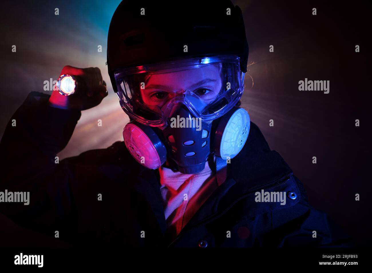 Robber in protective respirator looking at camera with shining ...