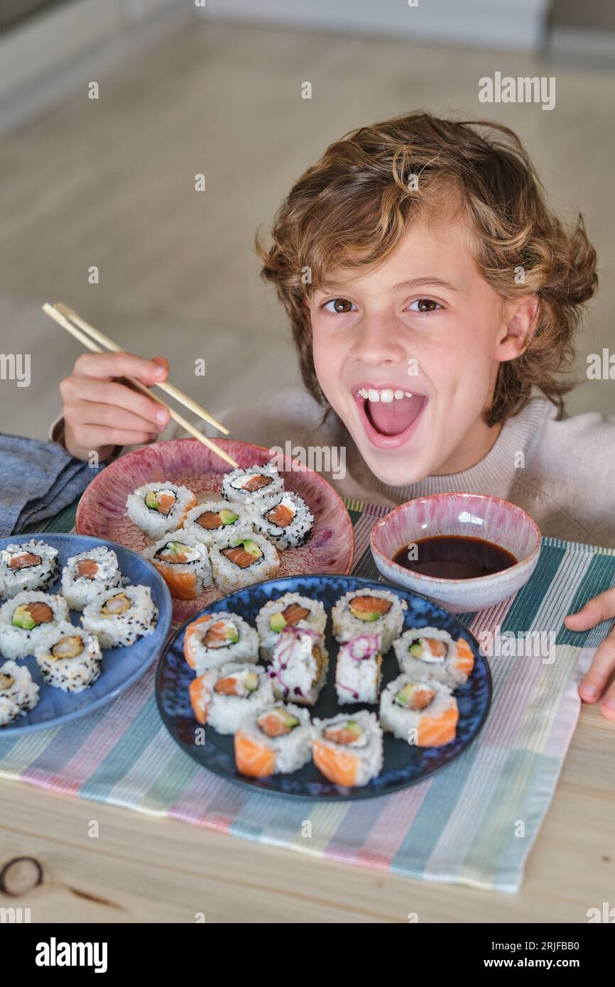 Boy eating sushi roll hi-res stock photography and images - Alamy