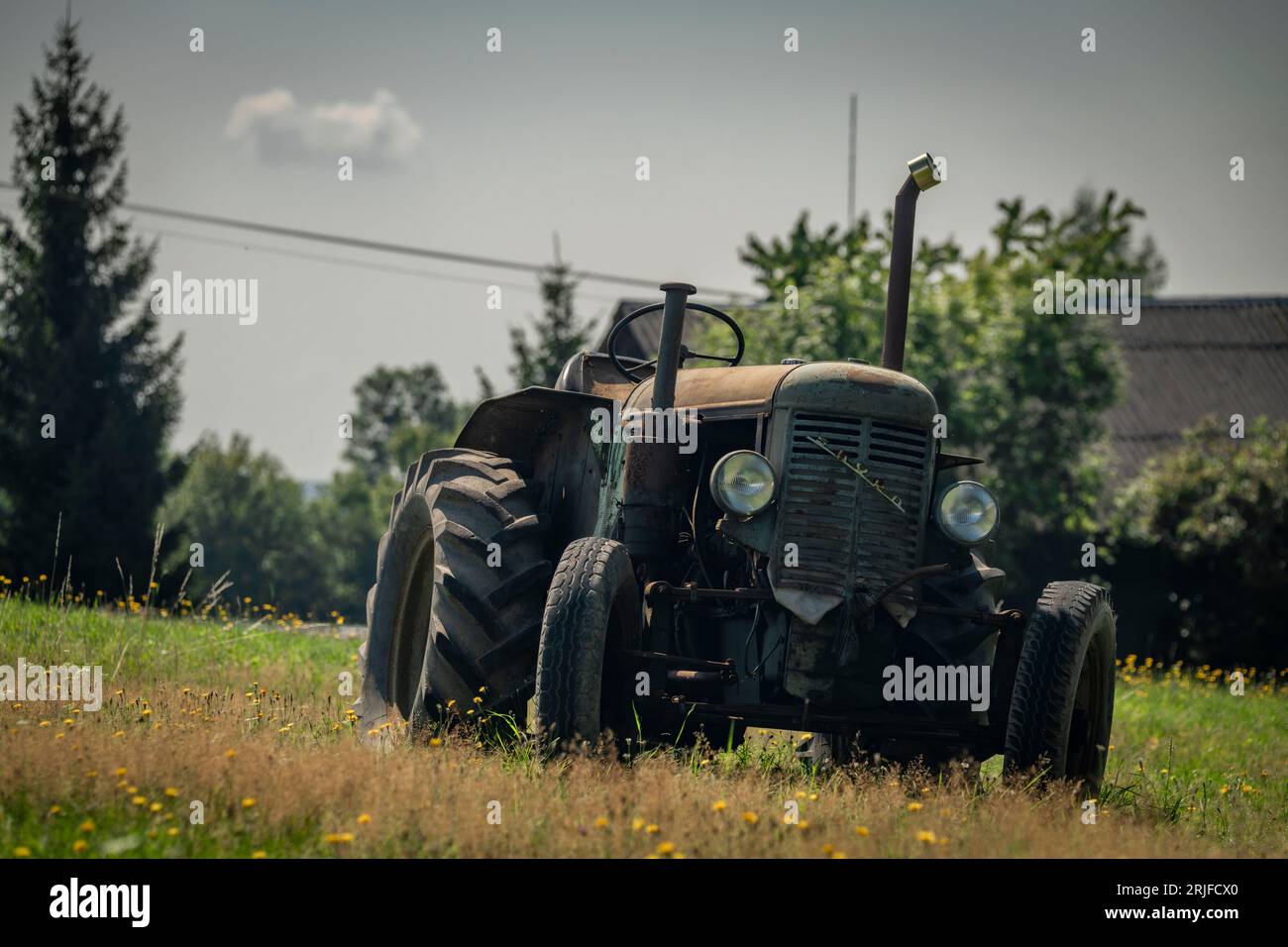 Scenic countryside with a old historic tractor in a field ready for ...