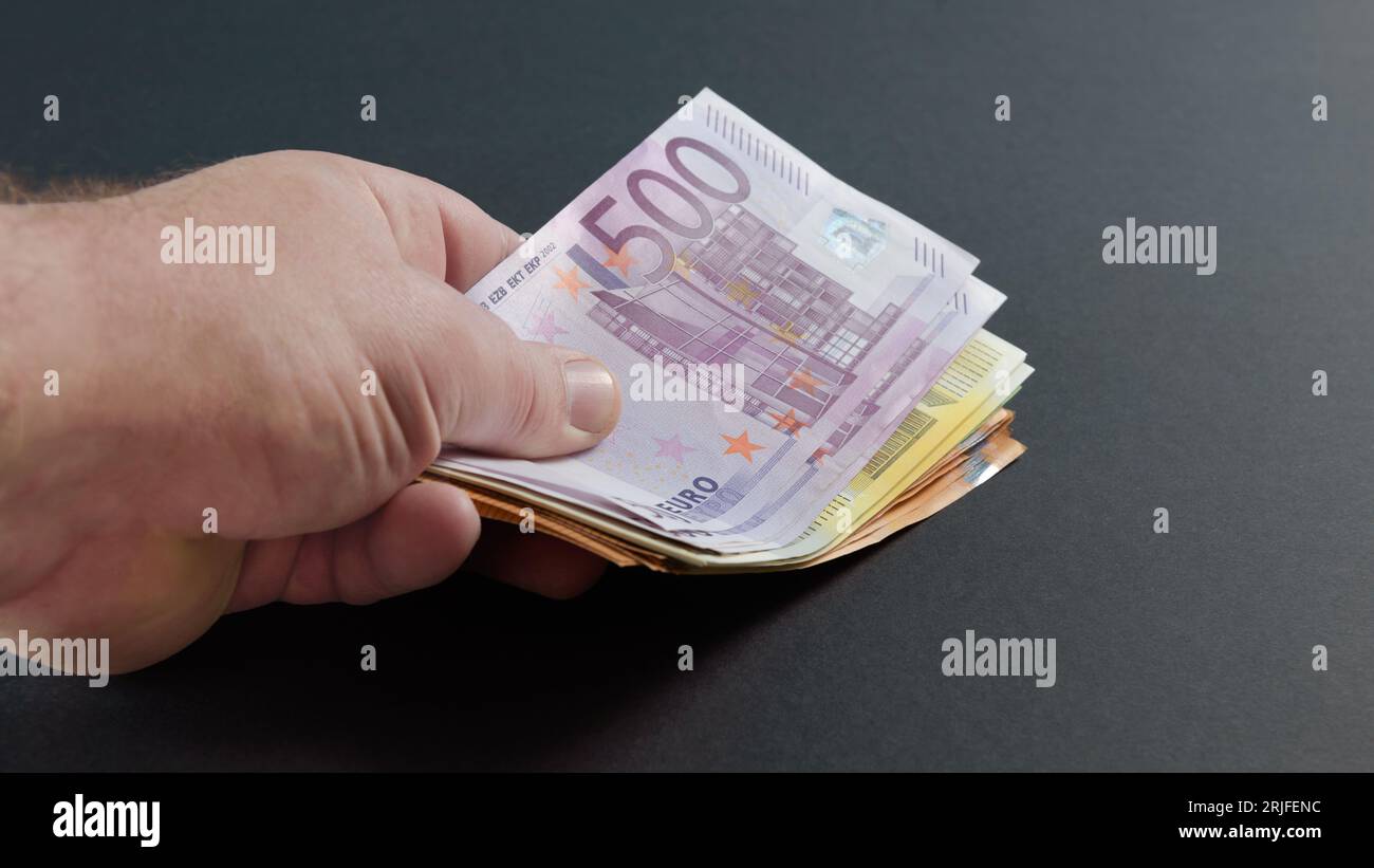 European cash payment. the hand holding large euro banknotes amount ...