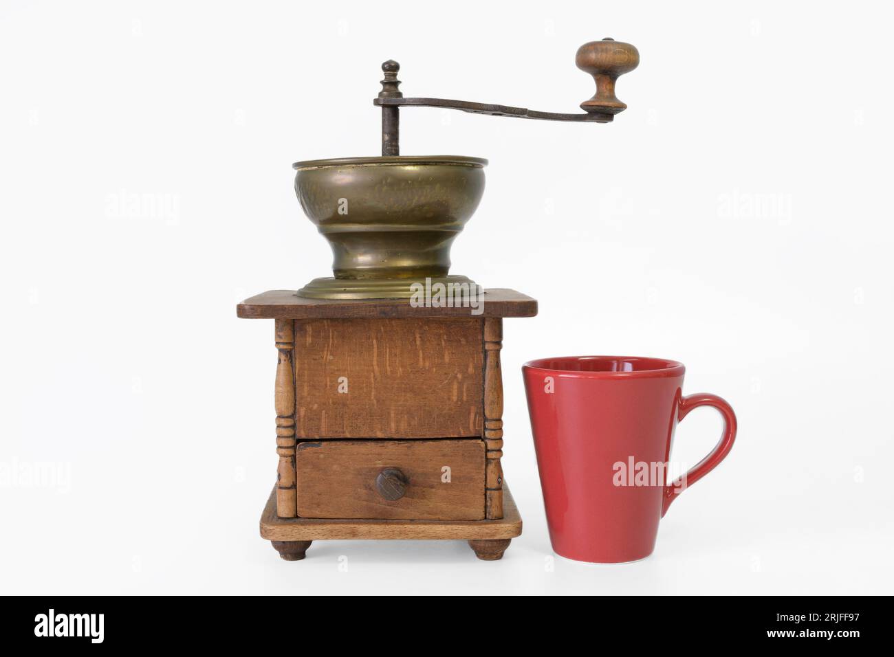 old wooden coffee mill and red coffee mug. white background, isolated ...