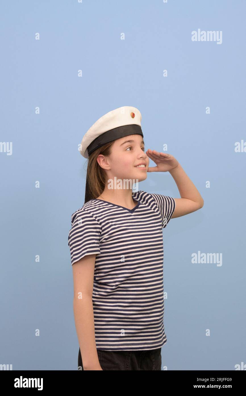 Sailor girl portrait on blue background. A teenage girl wearing a ...