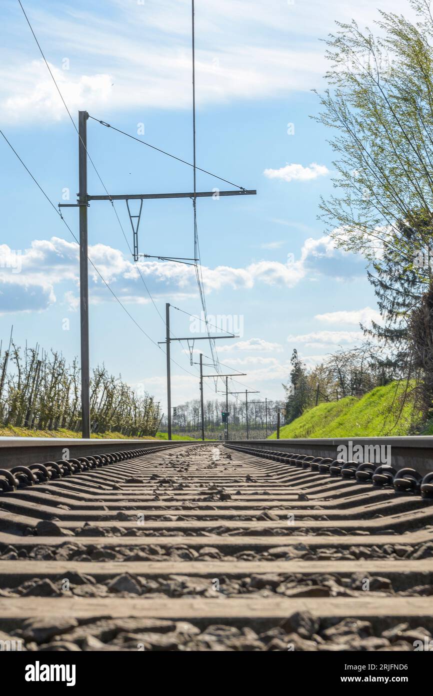 A perspective of the countryside of railway tracks in the middle ...