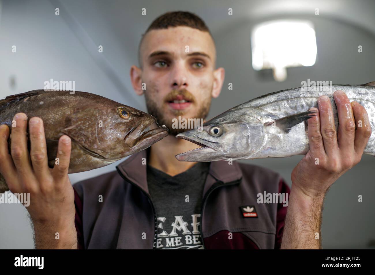 Gaza City, Palestine. 22nd Aug, 2023. A Palestinian fisherman displays ...