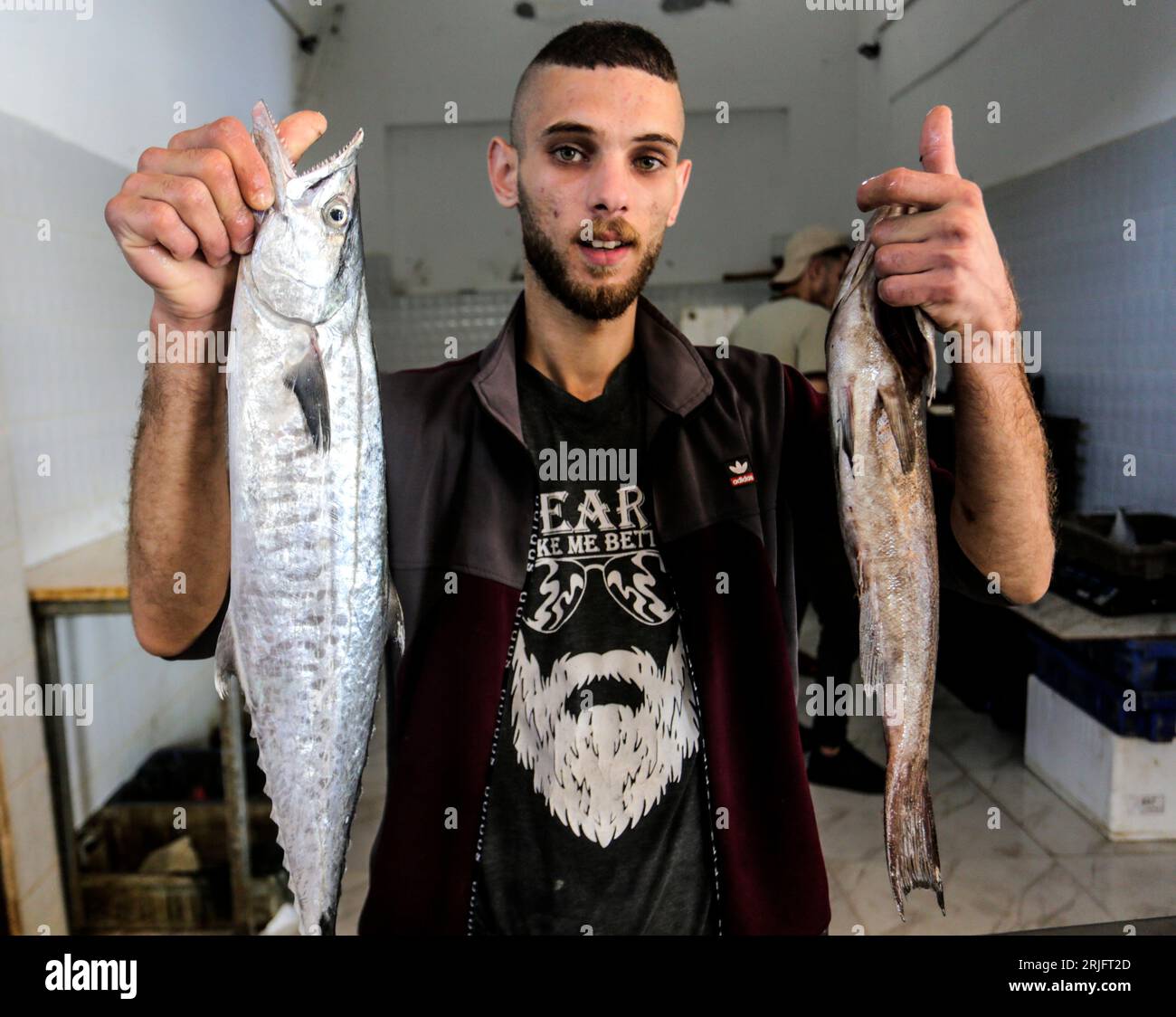 Gaza City, Palestine. 22nd Aug, 2023. A Palestinian fisherman displays ...