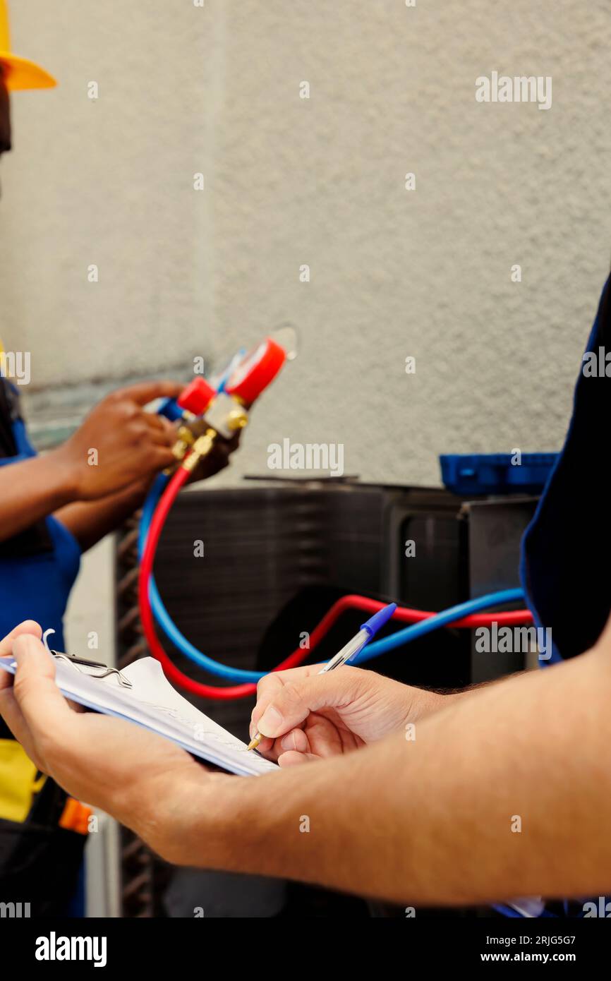 Trained engineers team tasked to do HVAC system check, refilling ...