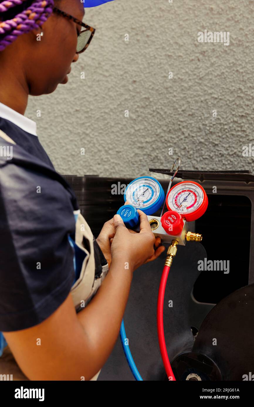 Precise serviceman tasked by client with restoring cooling capacity of hvac system by removing ...