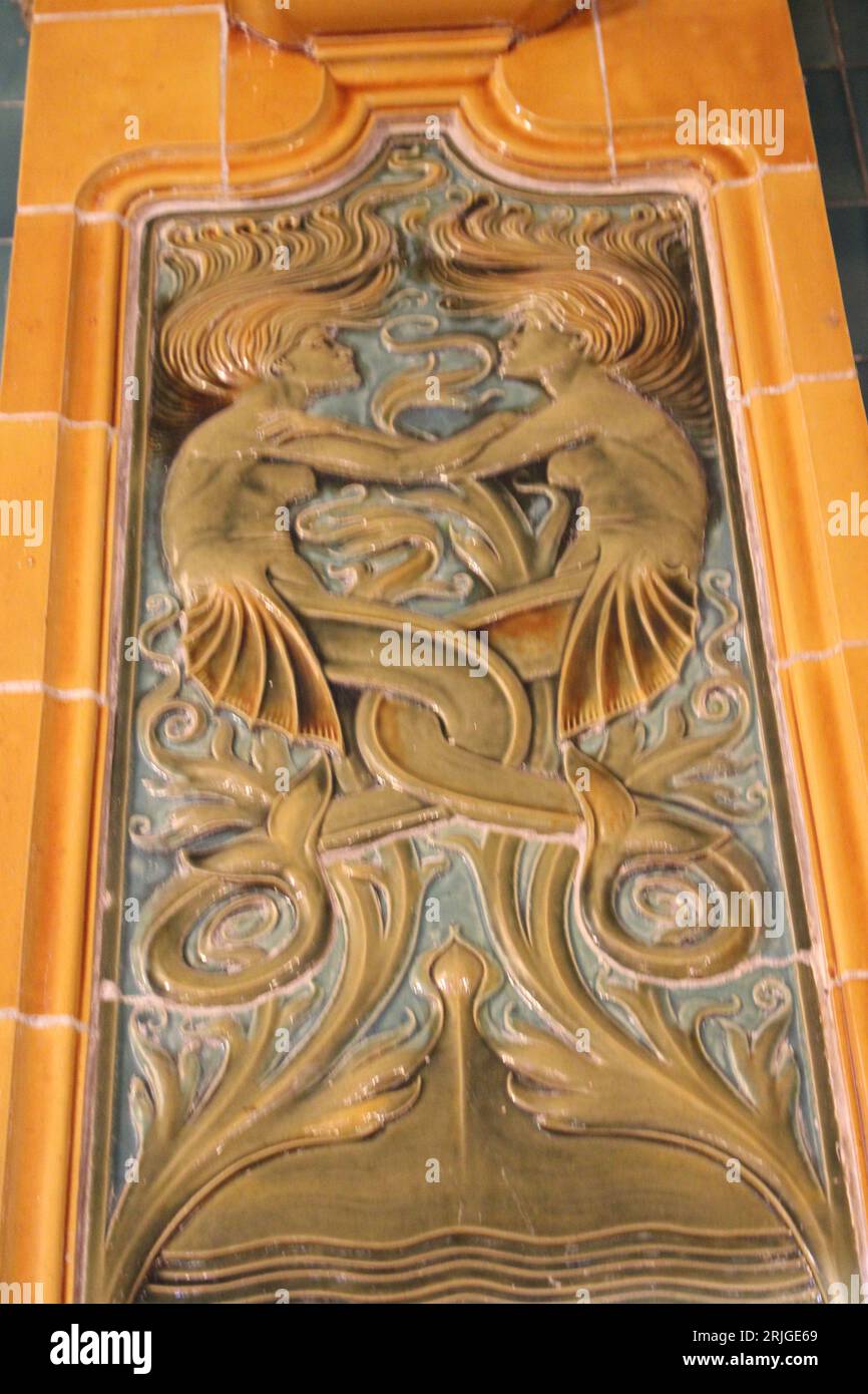 Art Deco bronze and green tiles depicting entwined creatures in the ...