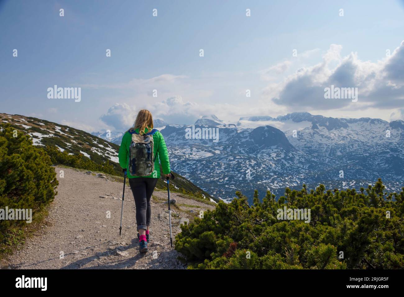Tourist woman trekking on Mount Krippenstein in the Dachstein Mountains ...