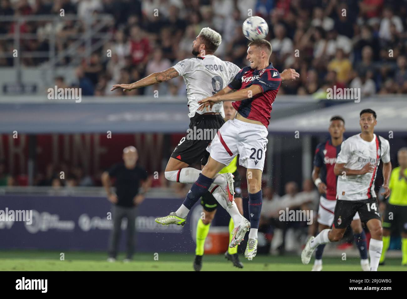 Olivier Giroud of AC Milan (L) and Michel Aebischer of Bologna (R) in ...