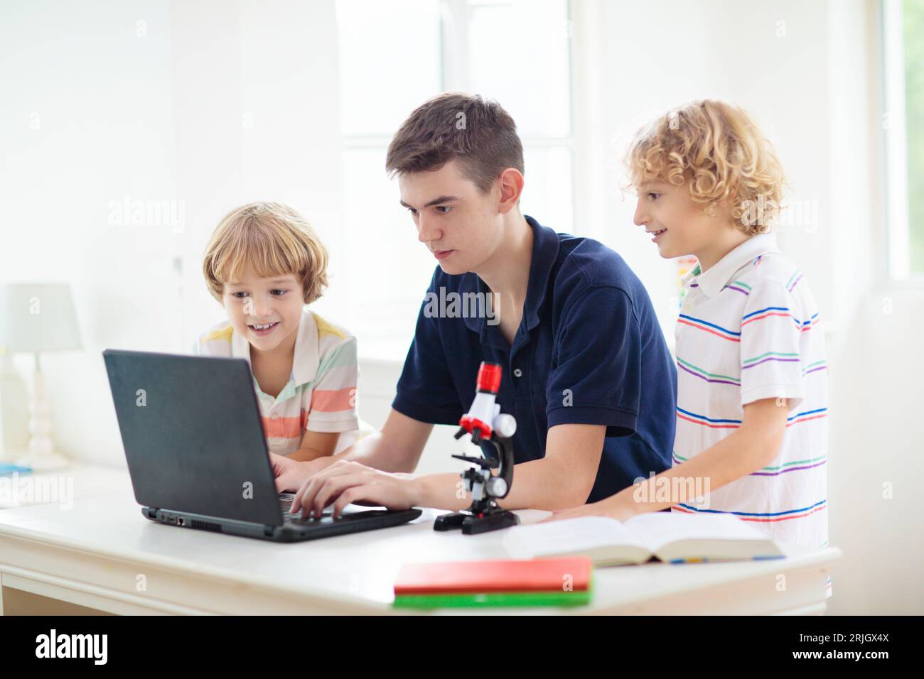School kids with microscope. Science class. Children making biology or ...