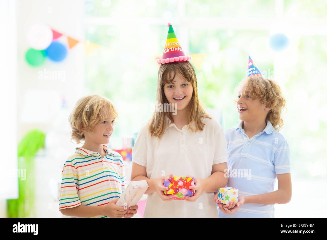 Kids birthday party. Children play with balloons and open presents ...