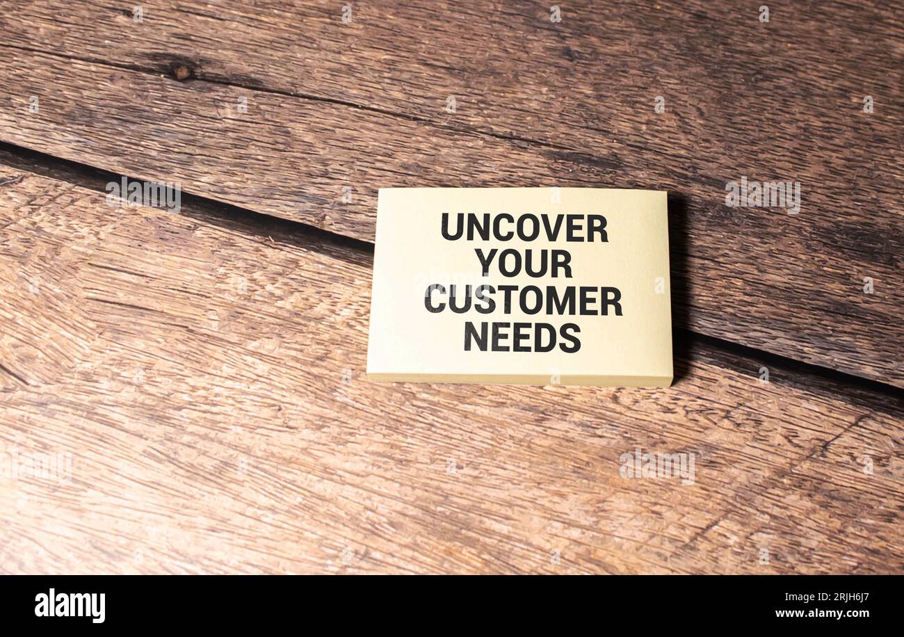 uncover your customer needs text on white notepad Stock Photo - Alamy
