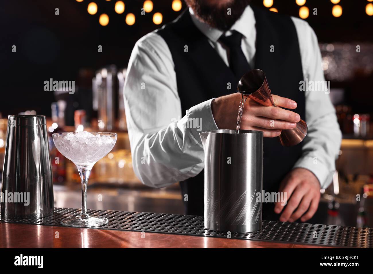 Bartender preparing fresh alcoholic cocktail at bar counter, closeup ...