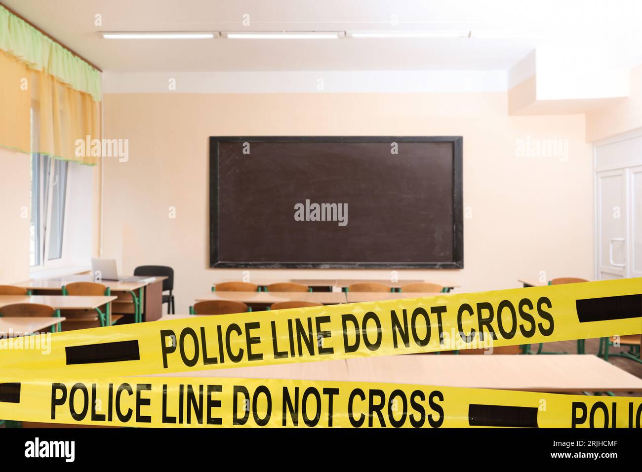 Yellow crime scene tape in empty school classroom Stock Photo - Alamy
