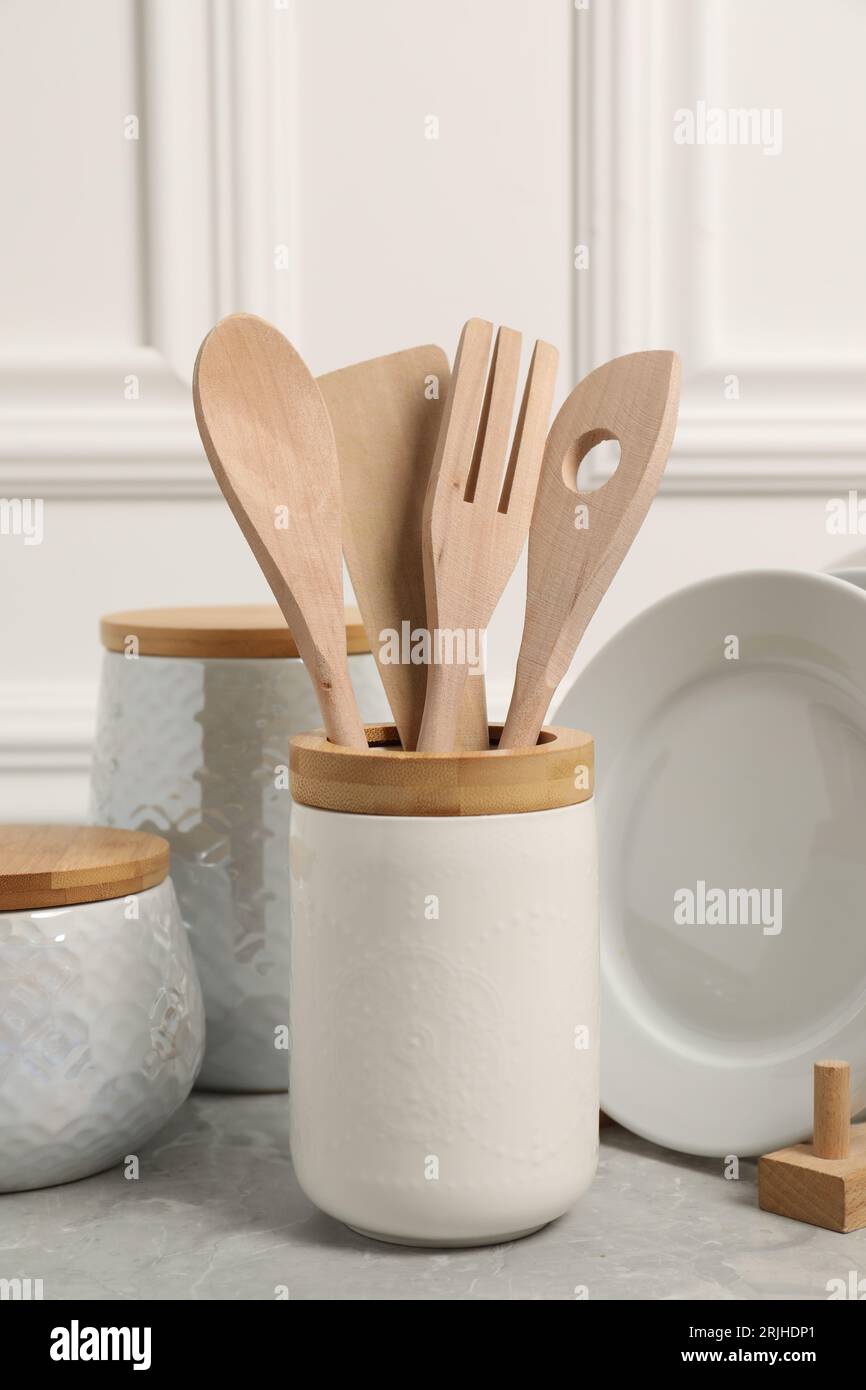 Set of different kitchenware on light gray table near white wall Stock ...