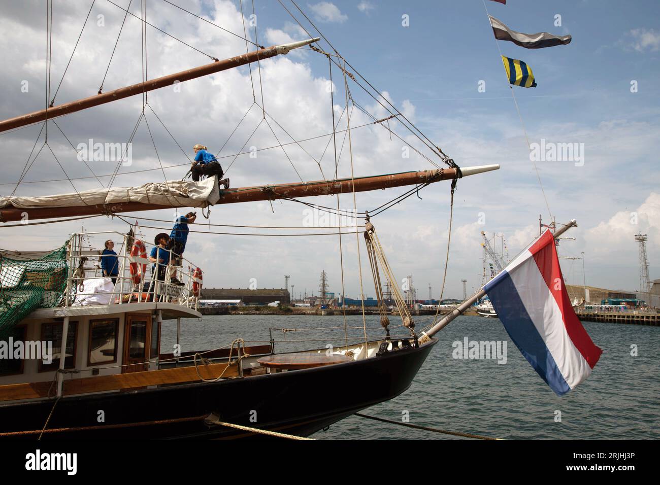 A group of people on an open-top boat are seen admiring the flags and ...
