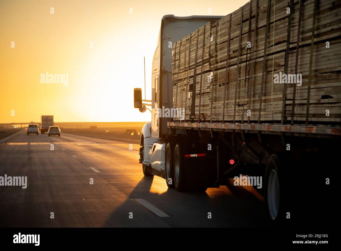 Long Haul 18 Wheel Truck driving on a highway with a load of lumber at ...