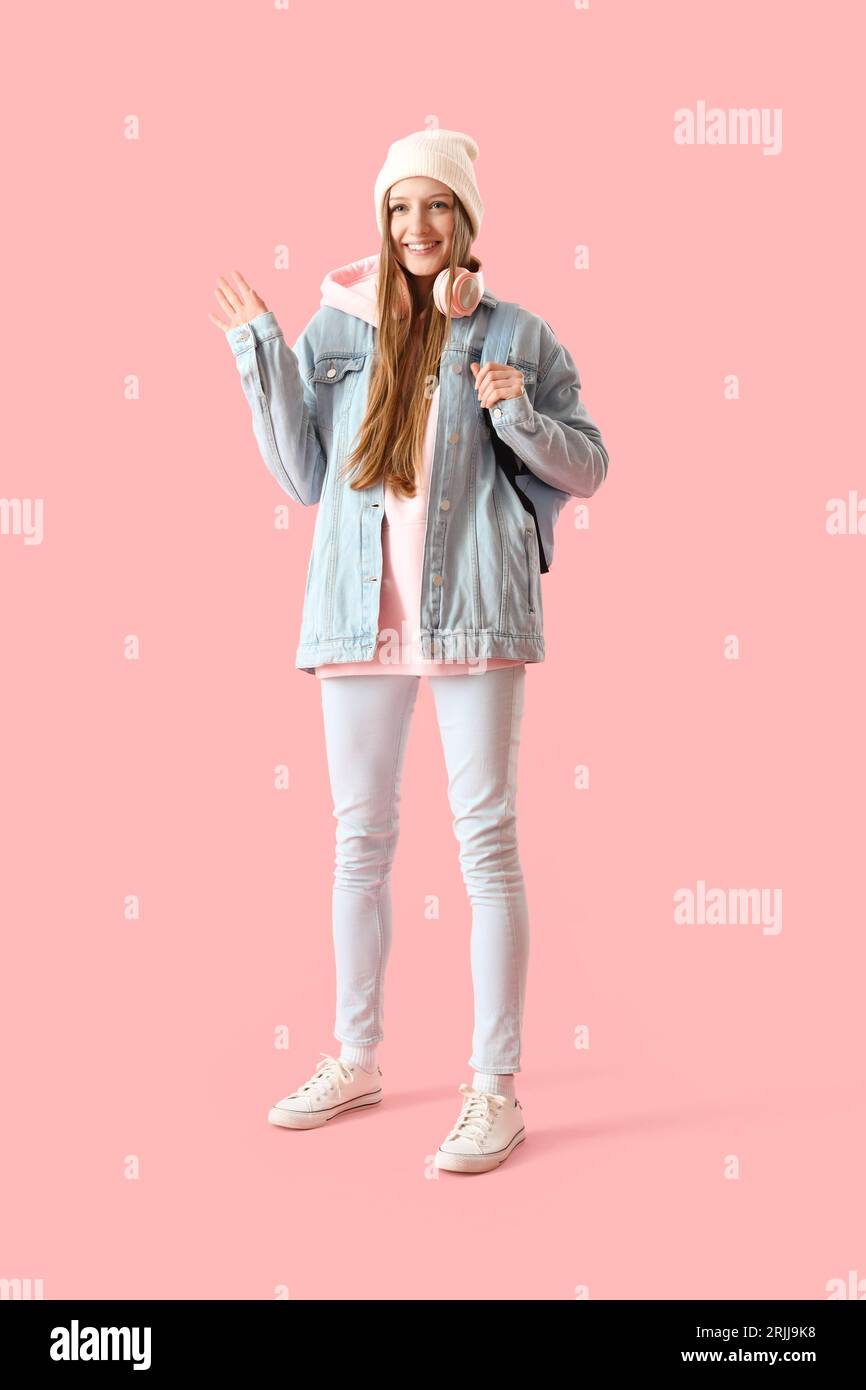 Female student waving hand on pink background Stock Photo - Alamy