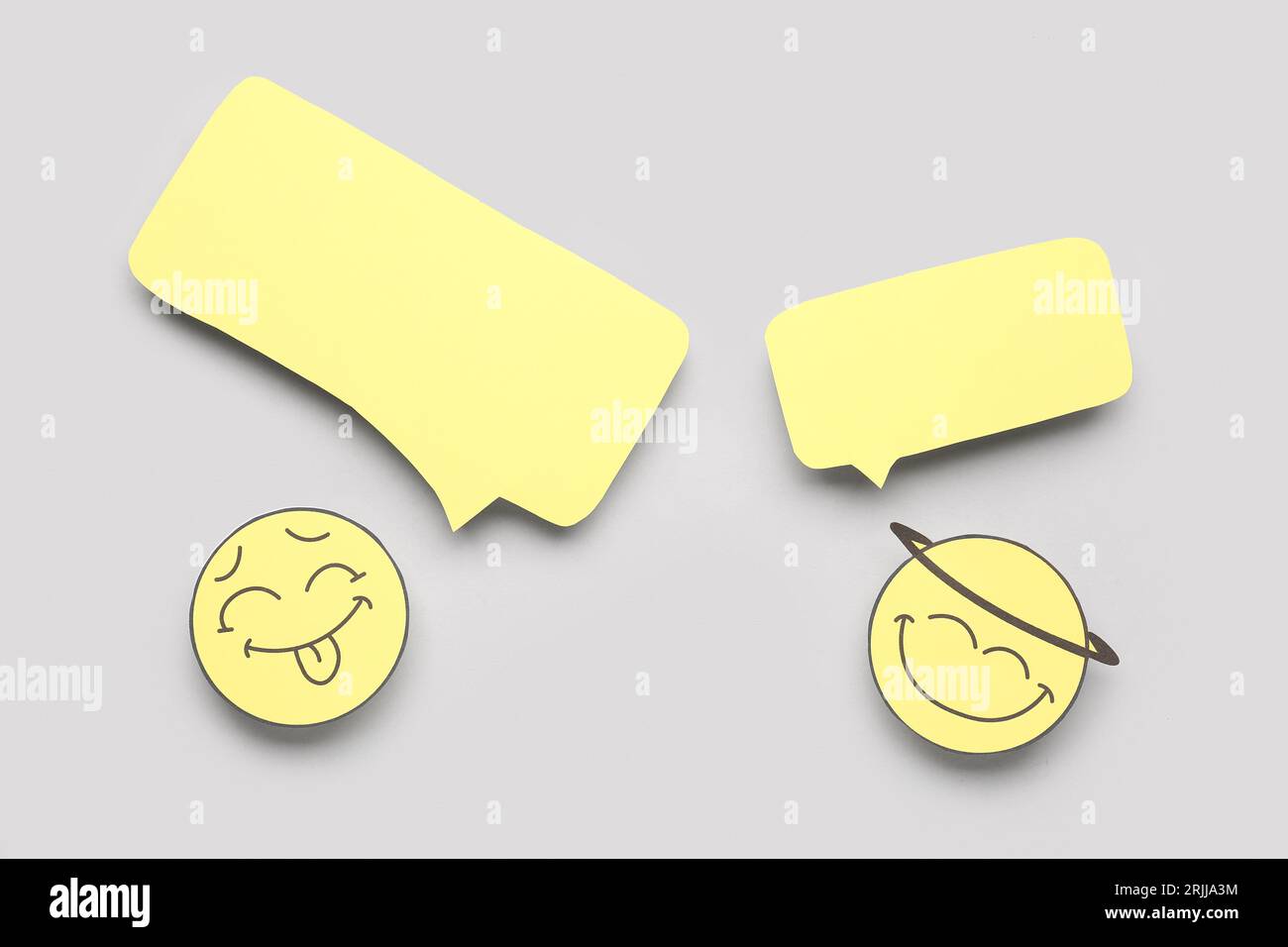 Paper faces with blank speech bubbles on grey background Stock Photo ...