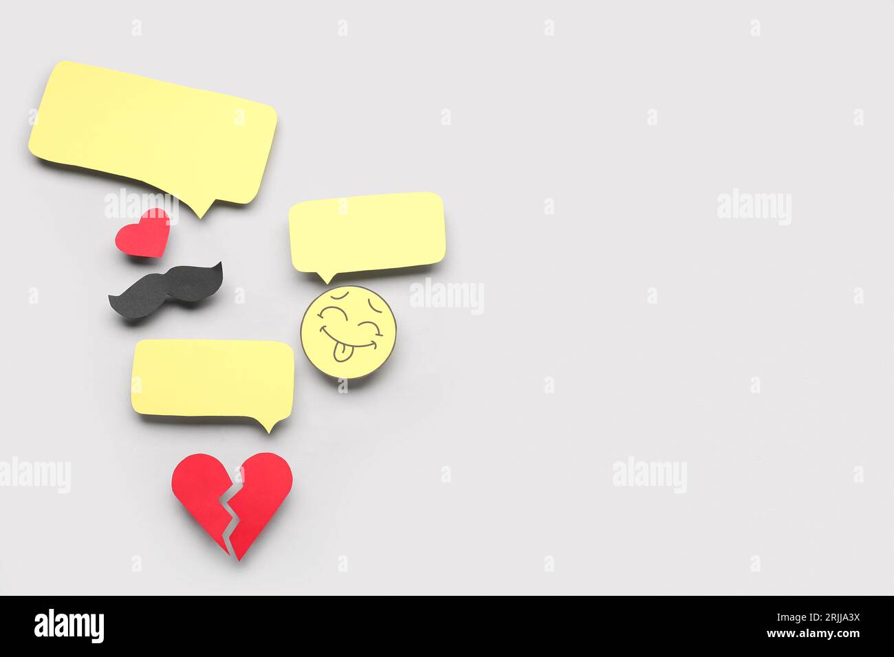 Paper face, mustache and broken heart with speech bubbles on grey background Stock Photo - Alamy