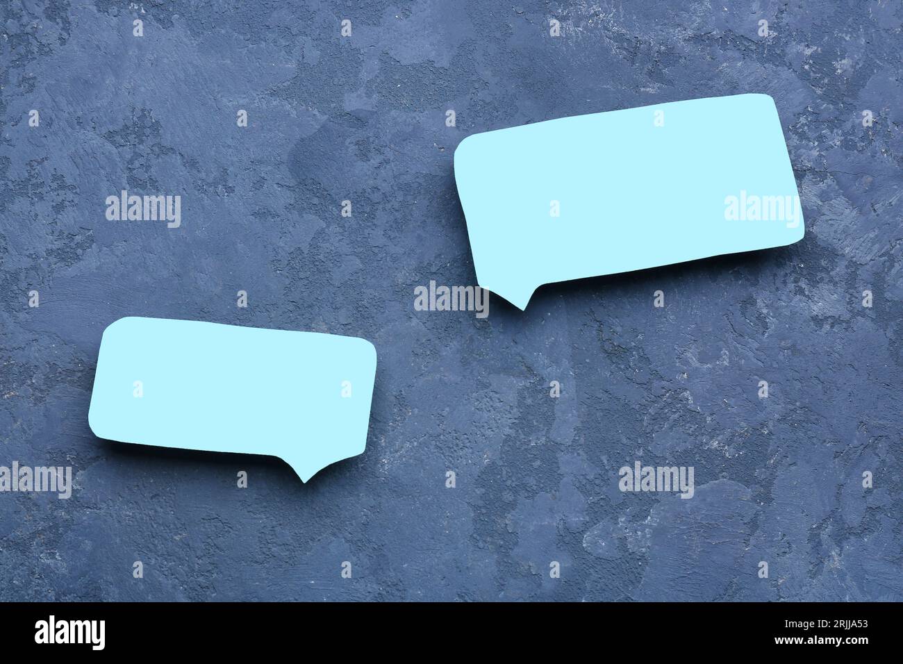 Blank speech bubbles on dark blue background Stock Photo - Alamy