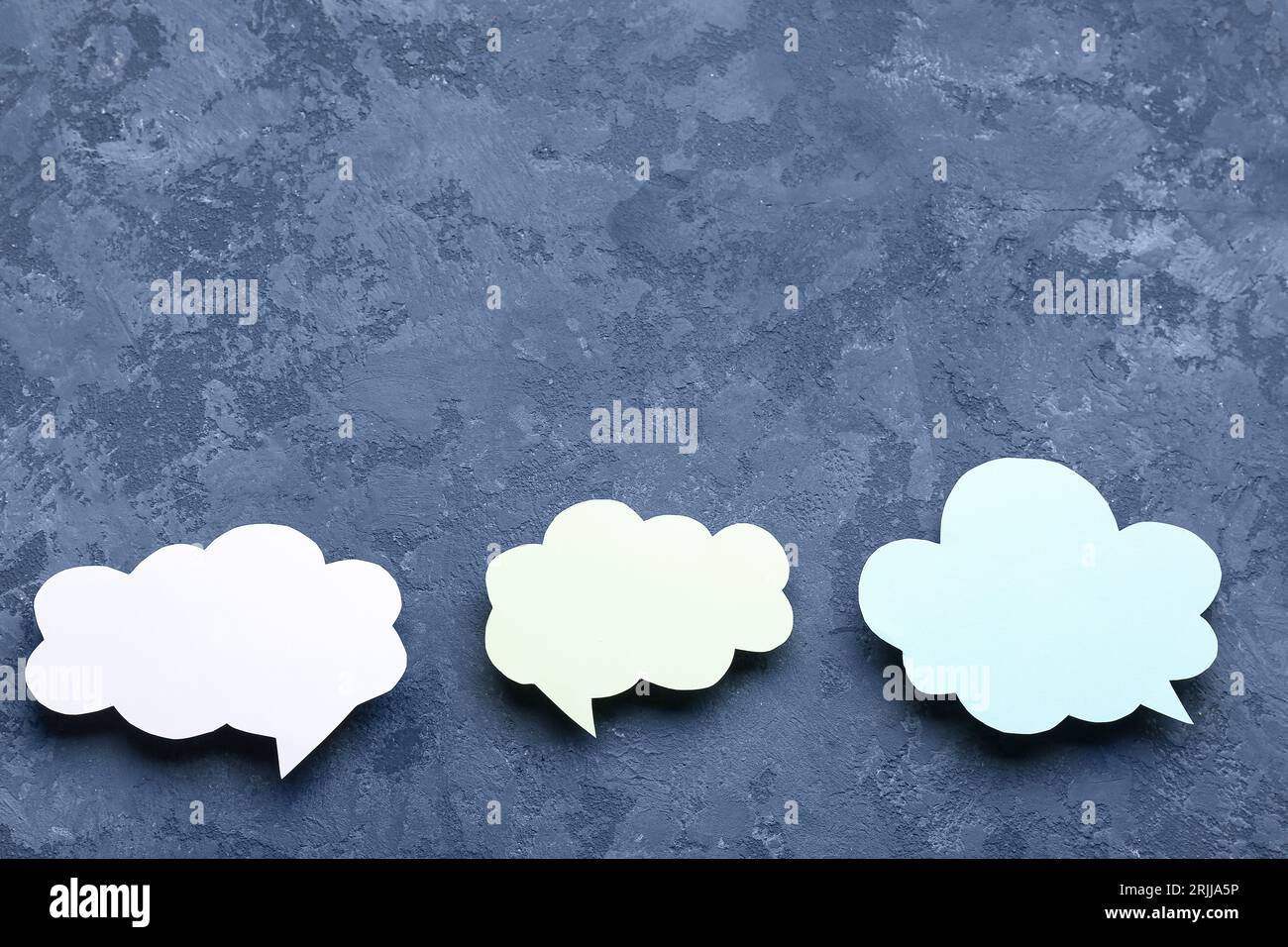 Blank speech bubbles on dark blue background Stock Photo - Alamy