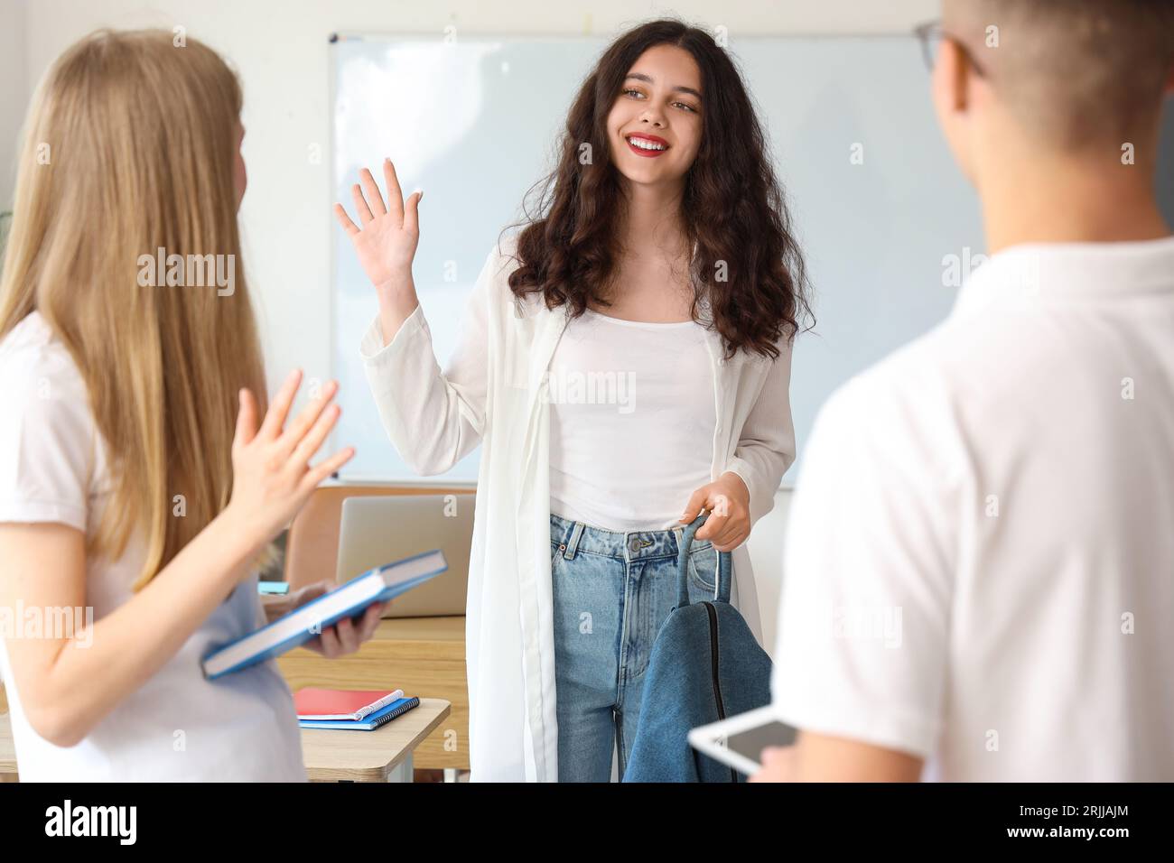 Female student with her classmates in classroom Stock Photo - Alamy
