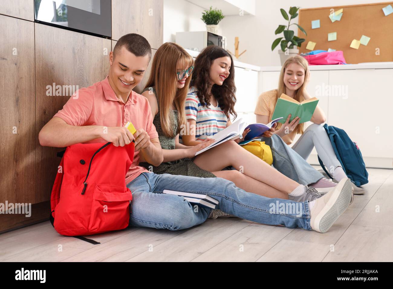 Group of students studying in kitchen Stock Photo - Alamy