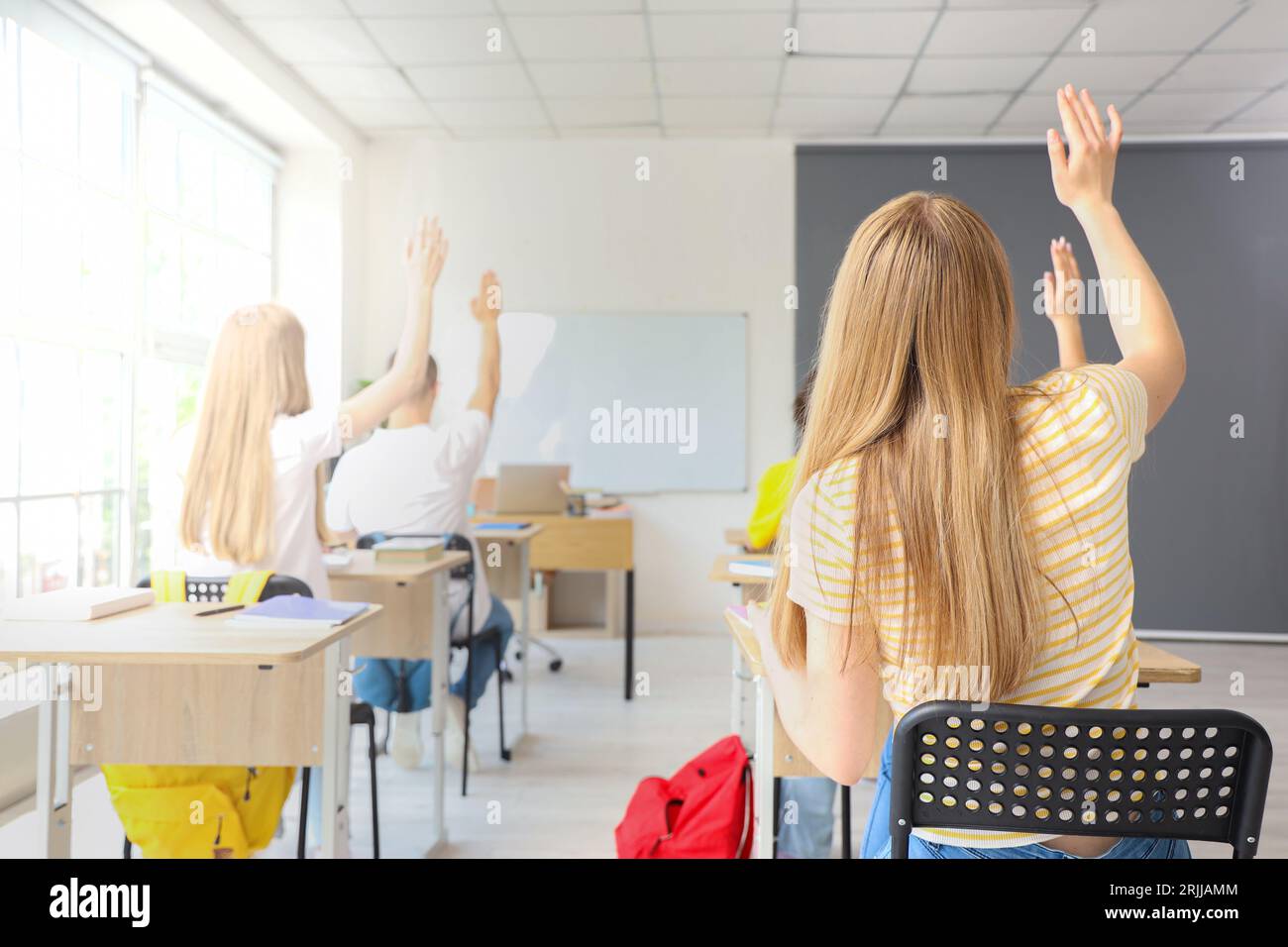 Group of students having lesson in classroom Stock Photo - Alamy
