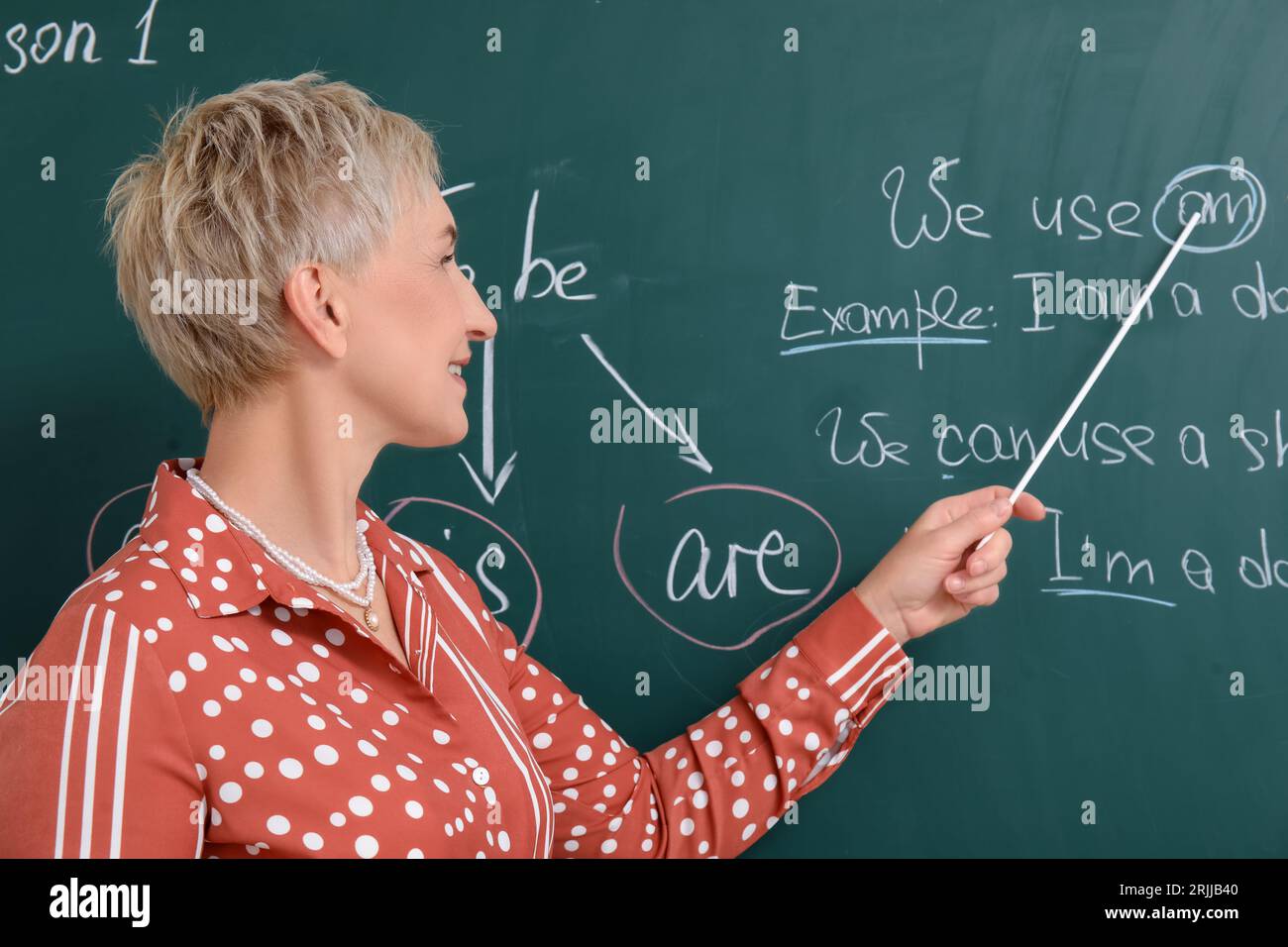 Female English teacher conducting grammar lesson in classroom Stock ...