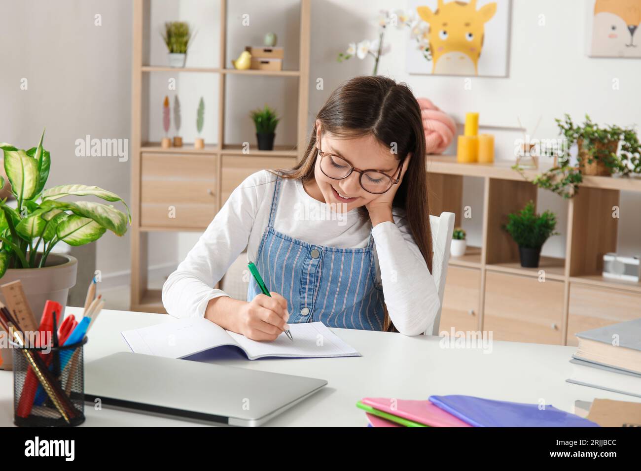 Little girl doing lessons at home Stock Photo - Alamy
