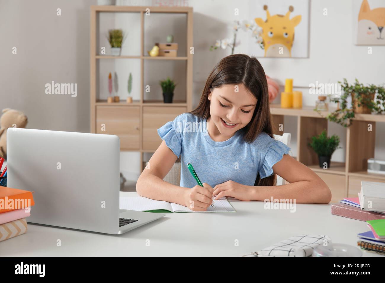 Little girl doing lessons at home Stock Photo - Alamy