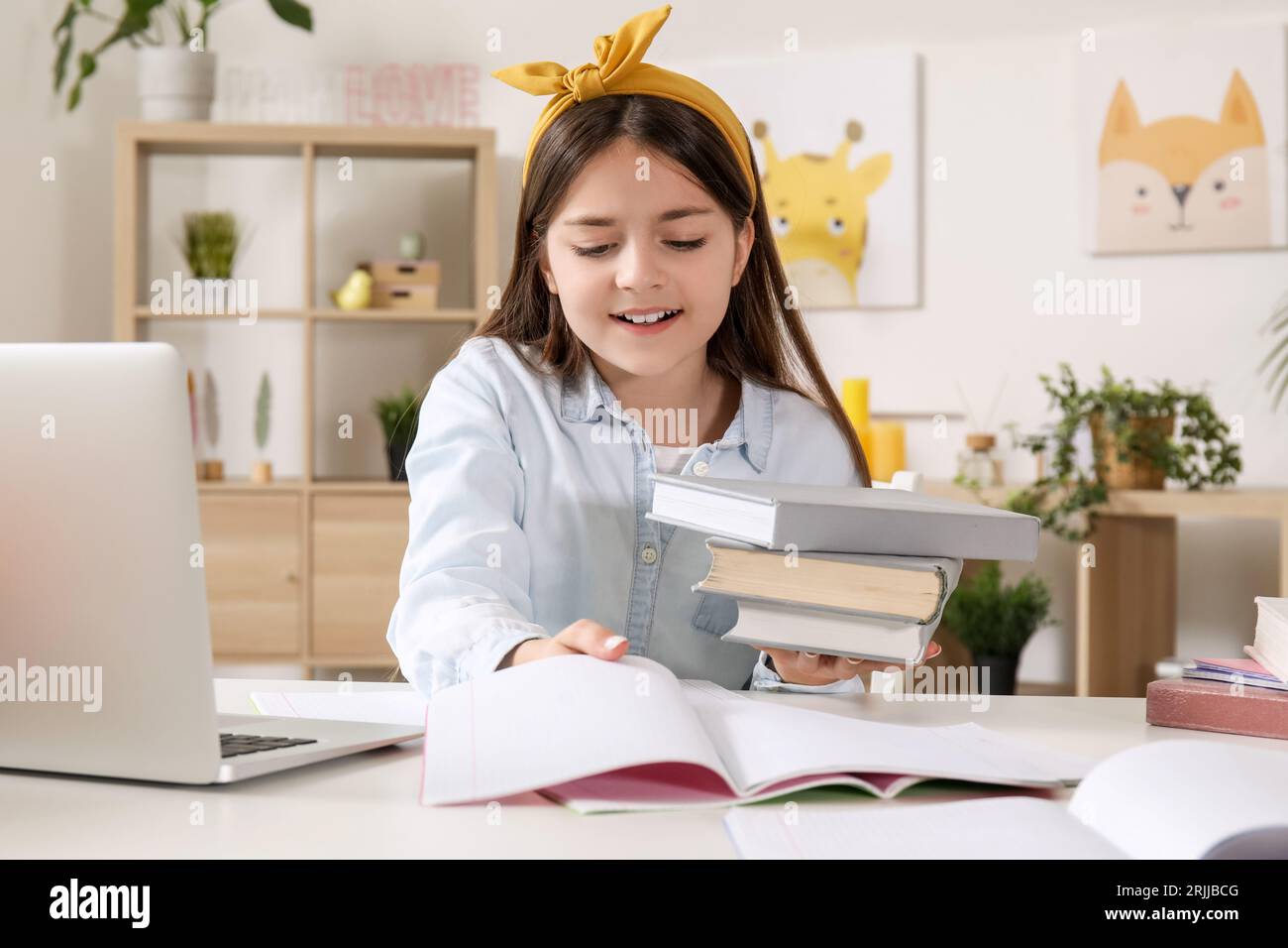 Little girl doing lessons at home Stock Photo - Alamy