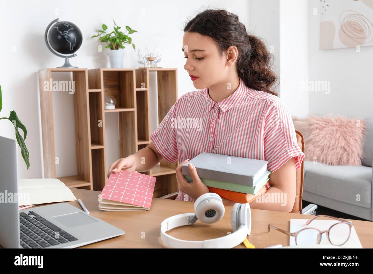 Female student doing lessons at home Stock Photo - Alamy