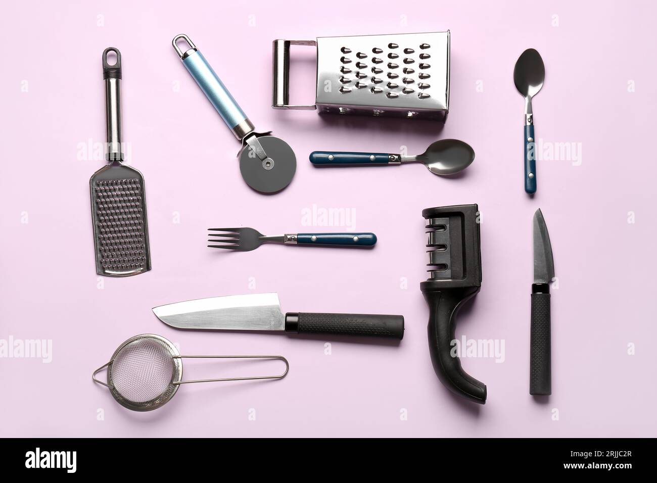 Set of different kitchen utensils on lilac background Stock Photo - Alamy