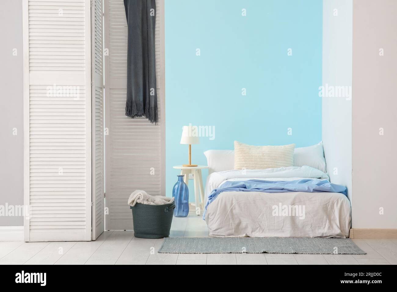 Modern bedroom interior with folding screen and bed Stock Photo - Alamy
