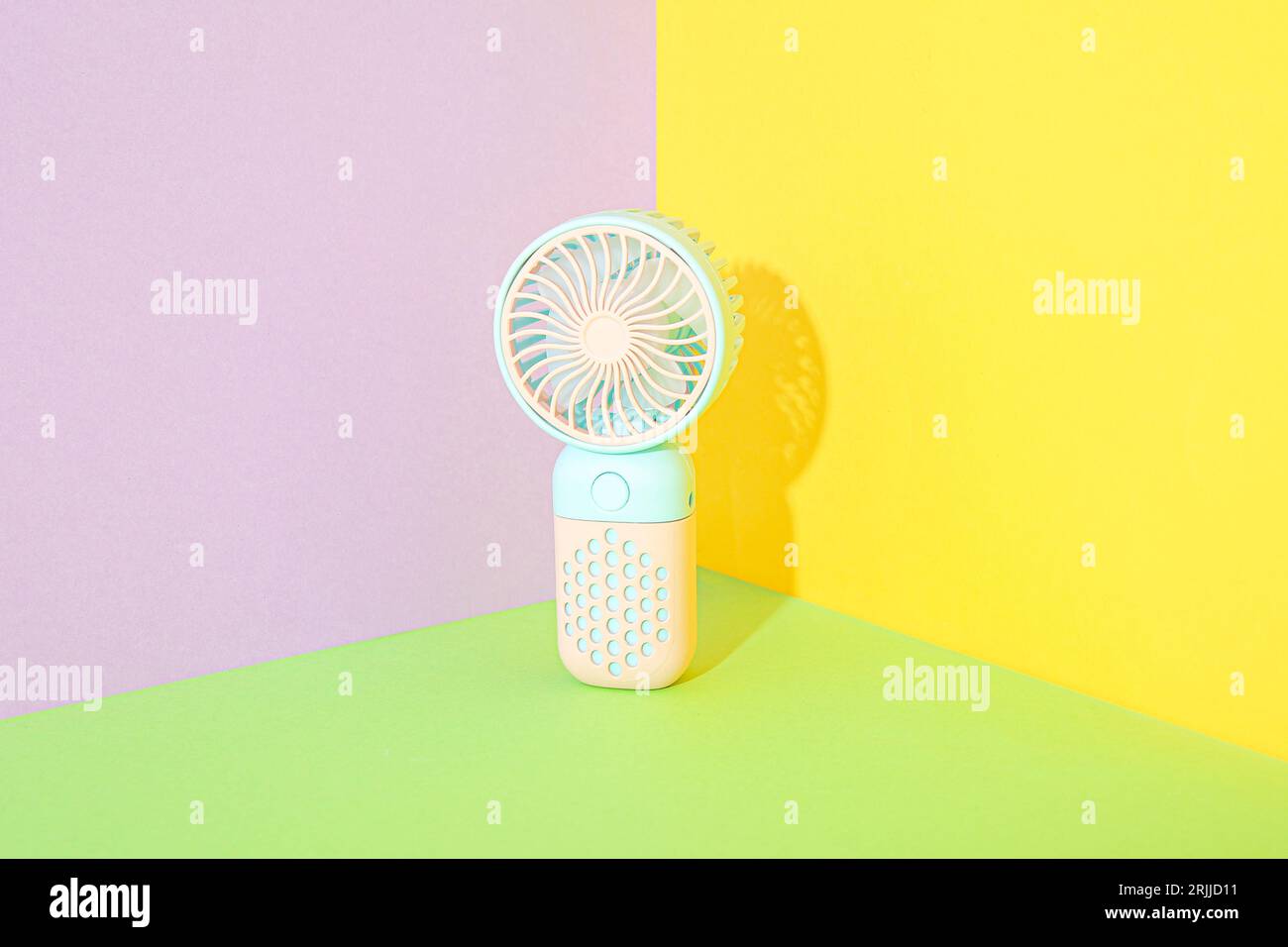 Small electric fan on colorful background Stock Photo - Alamy