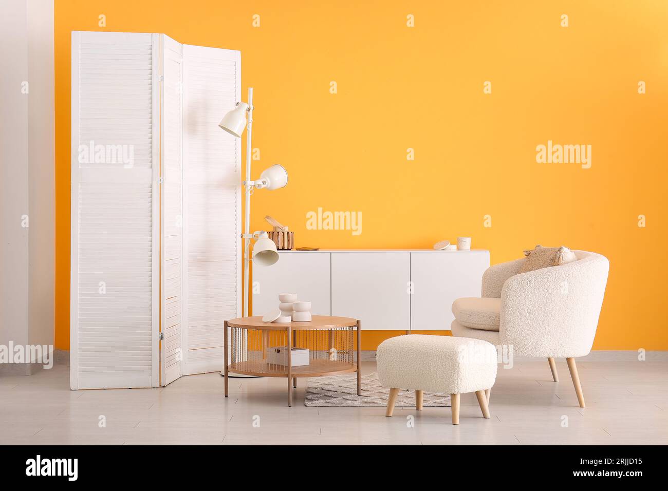 Modern living room interior with folding screen, white armchair and ...