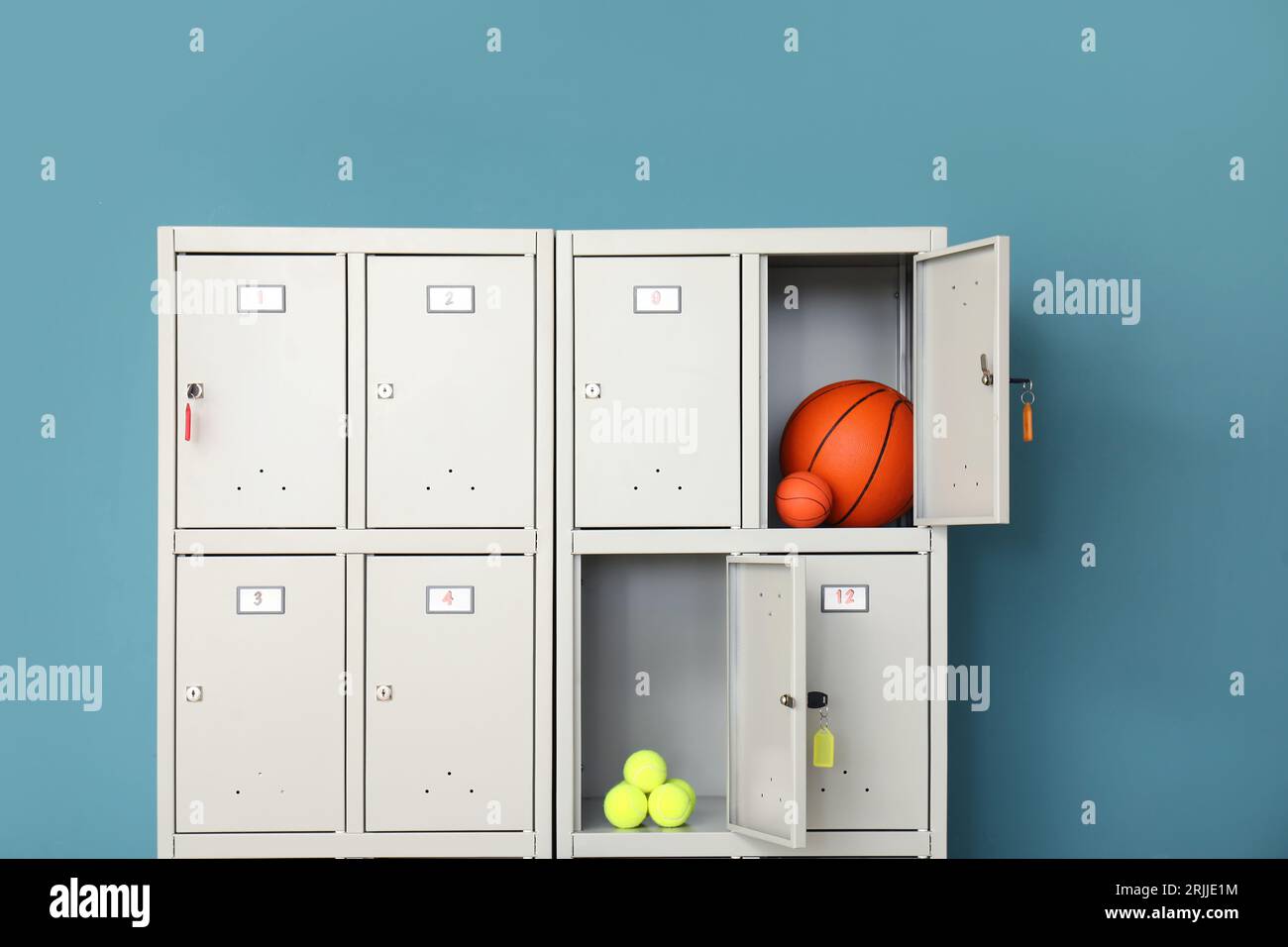 Modern locker with sports equipment near blue wall Stock Photo - Alamy