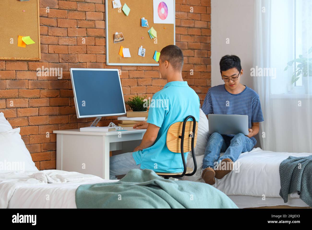 Male students studying in dorm room Stock Photo - Alamy
