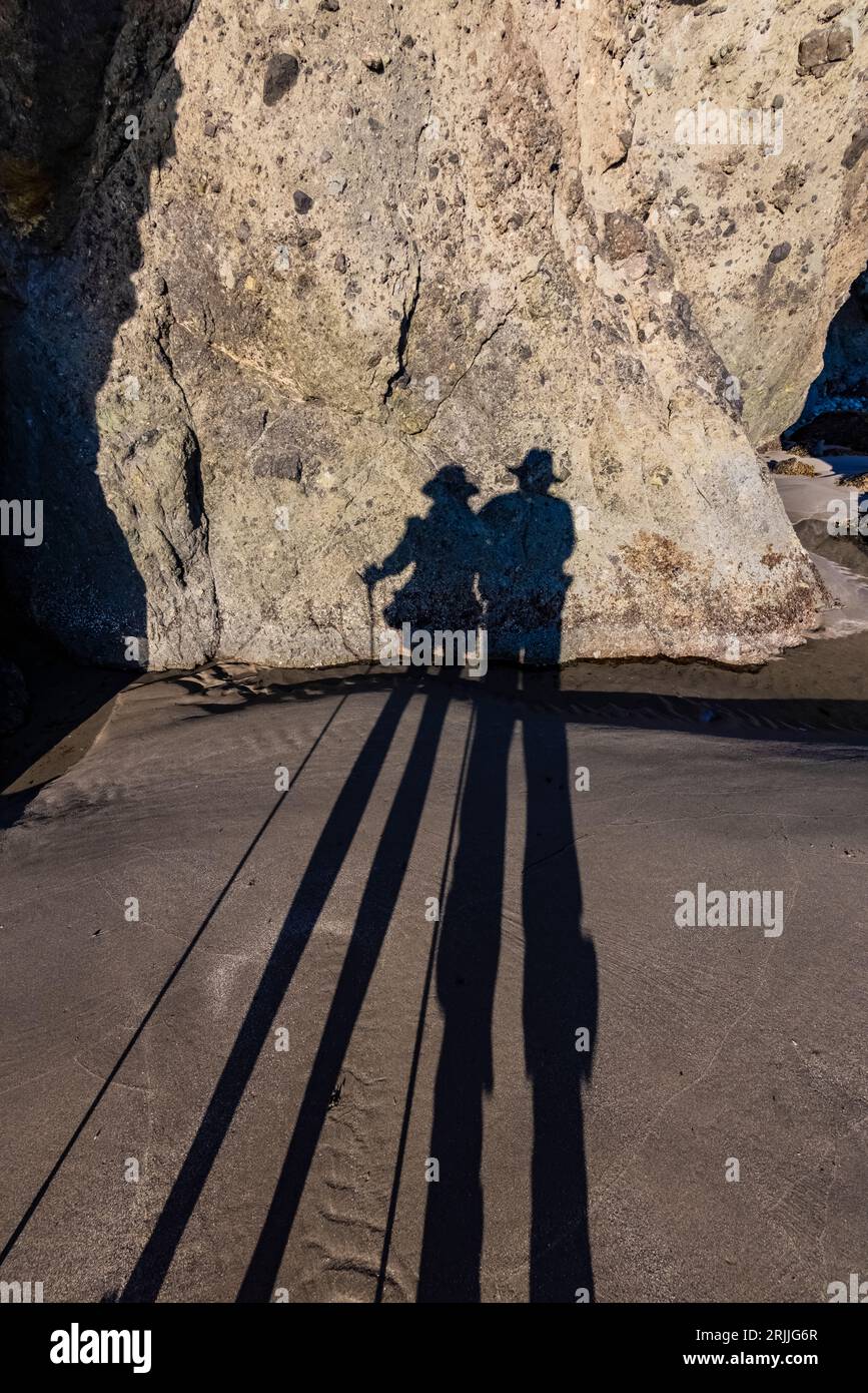 Shadows cast by setting sun on pair of hikers at Point of Arches ...