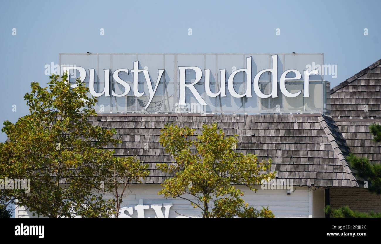 Dewey Beach, Delaware, U.S.A - August 18, 2023 - The top sign of the famous Rusty Rudder ...