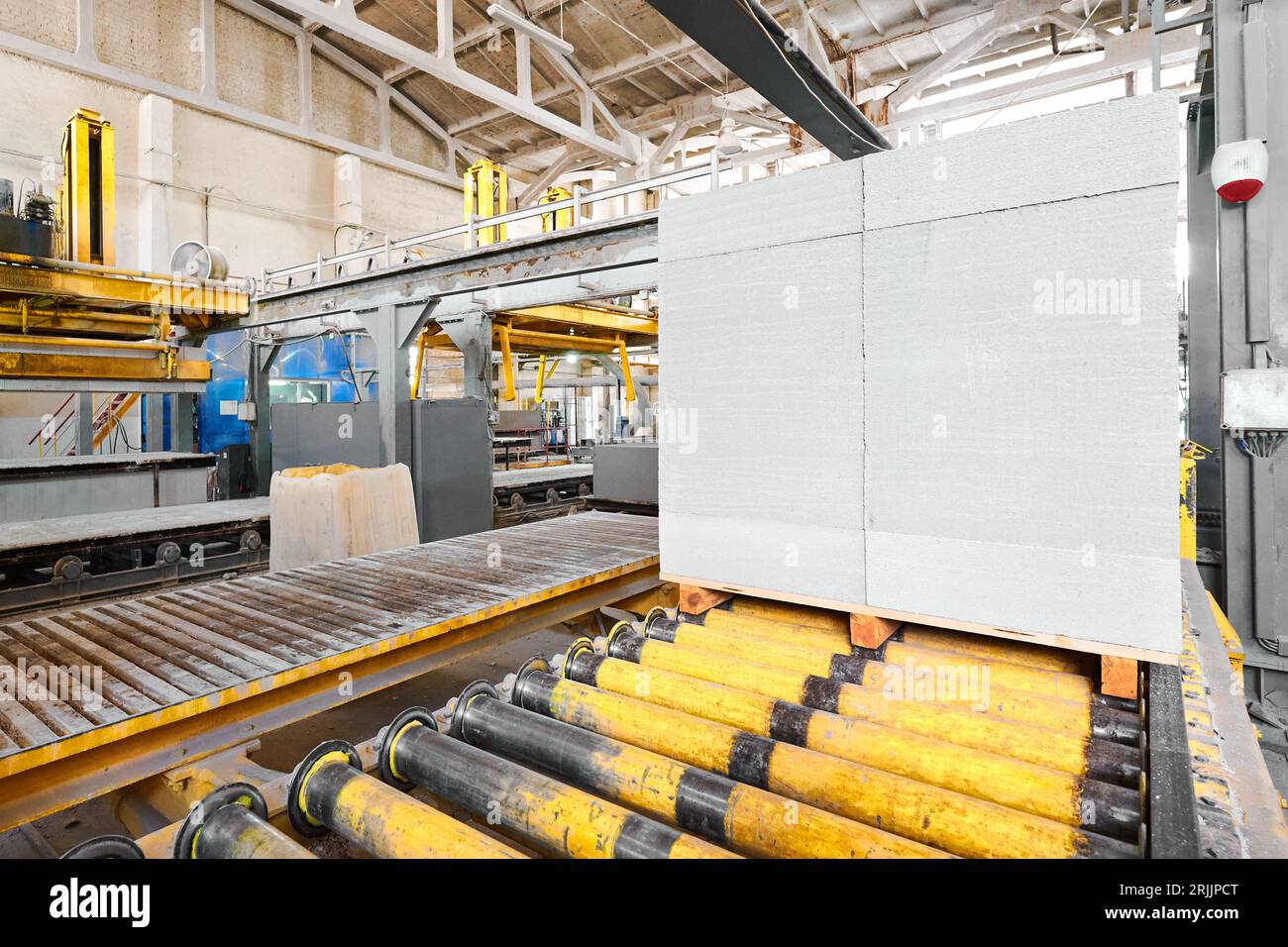 Stack of finished blocks on roller conveyor at plant Stock Photo - Alamy