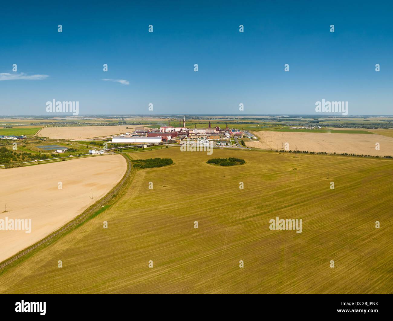 Illuminated potassium salt mine landscape among fields Stock Photo - Alamy
