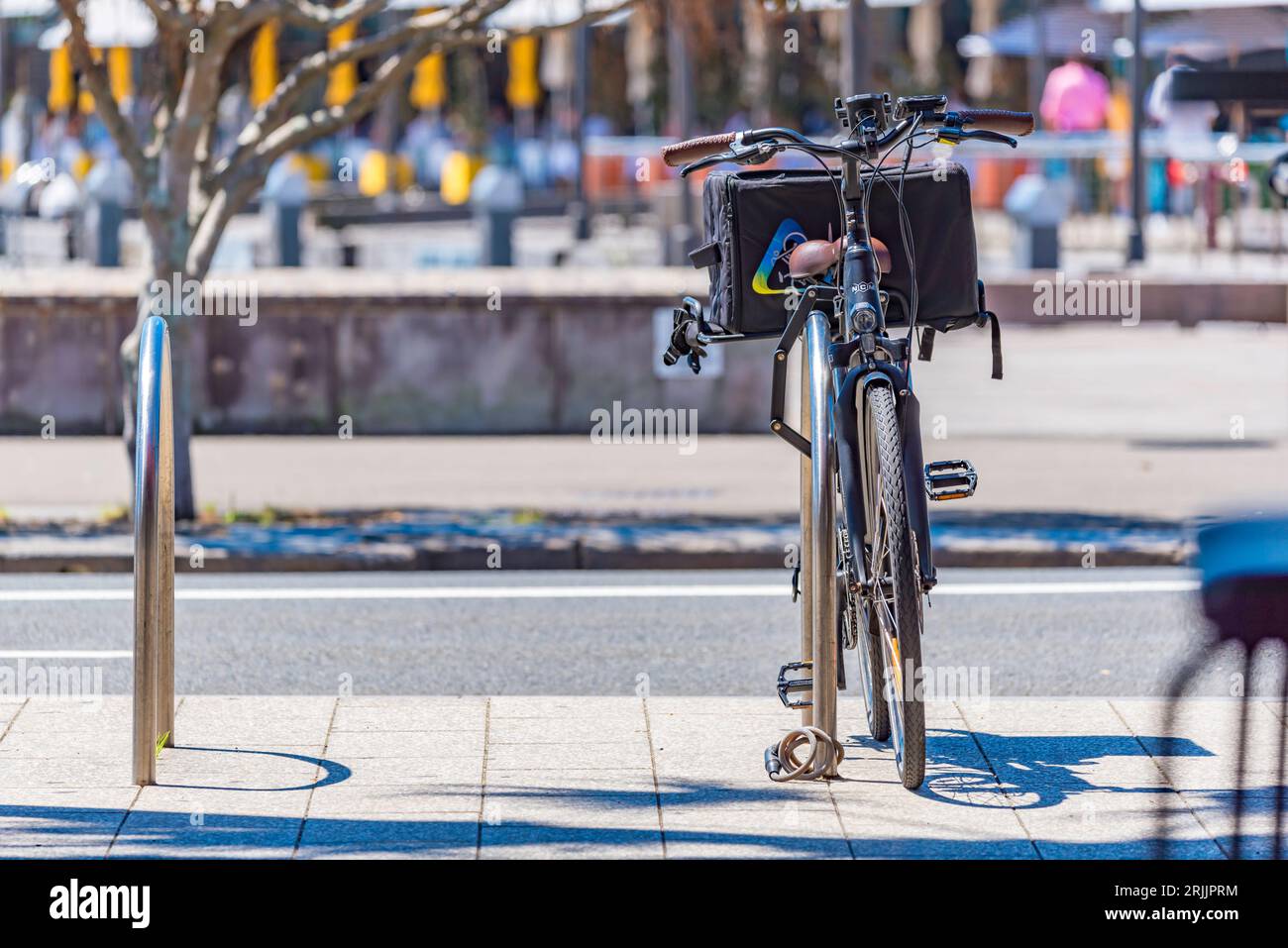 A food courier bicycle chained to a bike parking hoop in Woolloomooloo ...