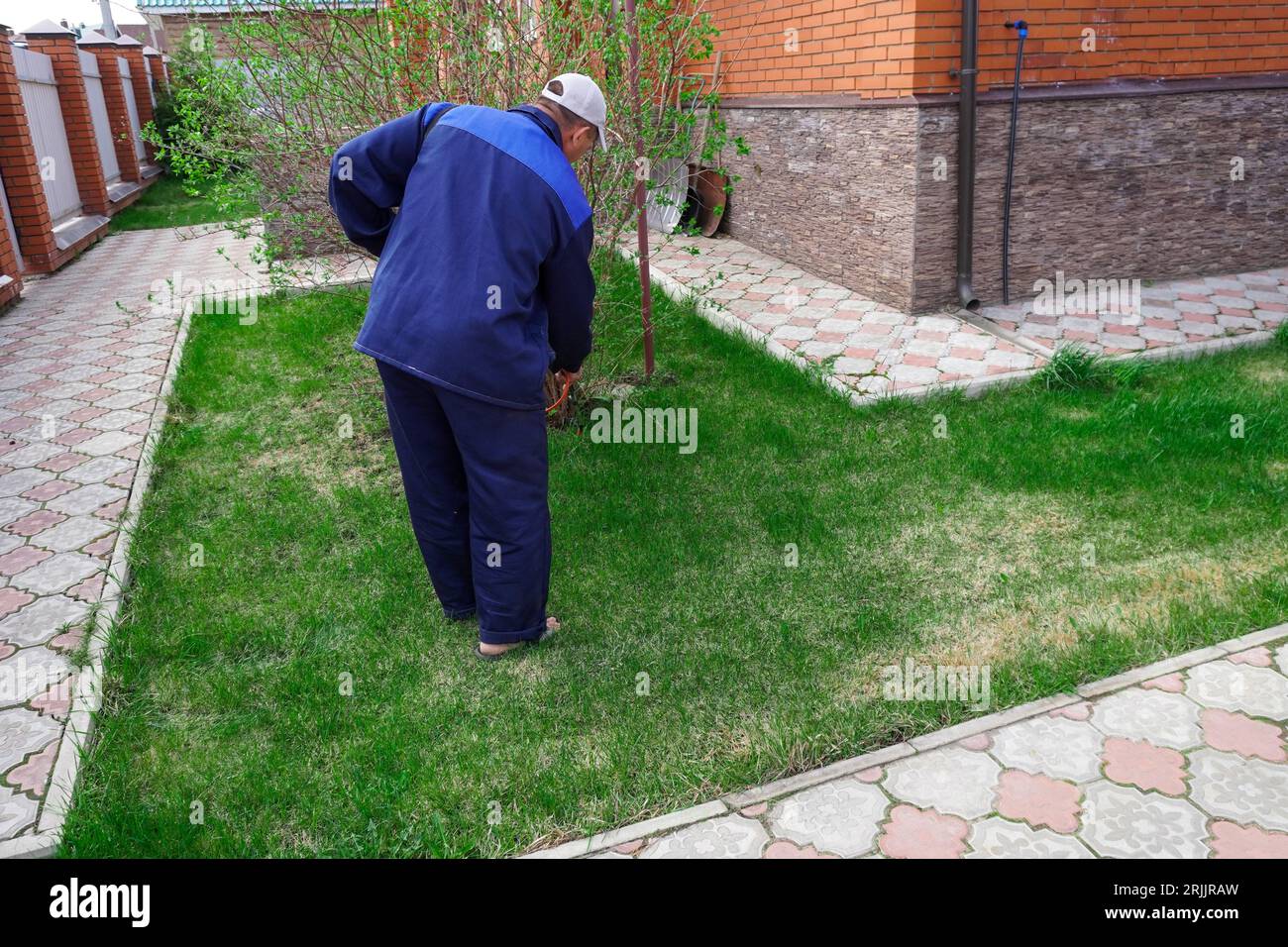 Gardener spraying weeds hi-res stock photography and images - Alamy