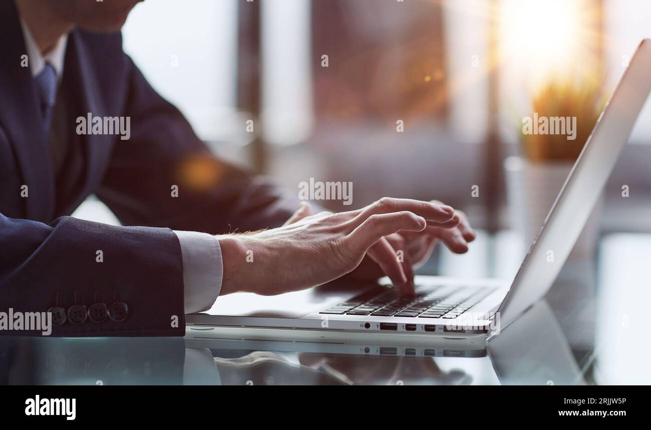 Closeup image of a man working and typing on laptop computer keyboard ...