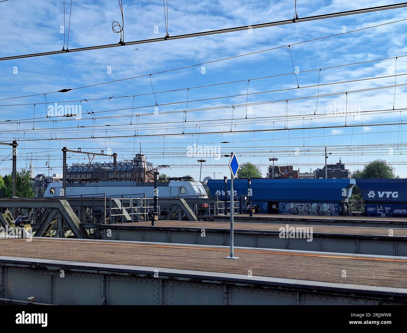 Traxx locomotive with hopper cargo cars are passing the Amsterdam ...